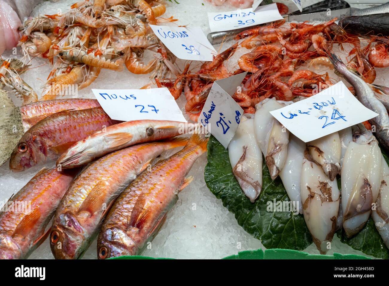 Fish, squid and prawns for sale at a market in Barcelona Stock Photo ...