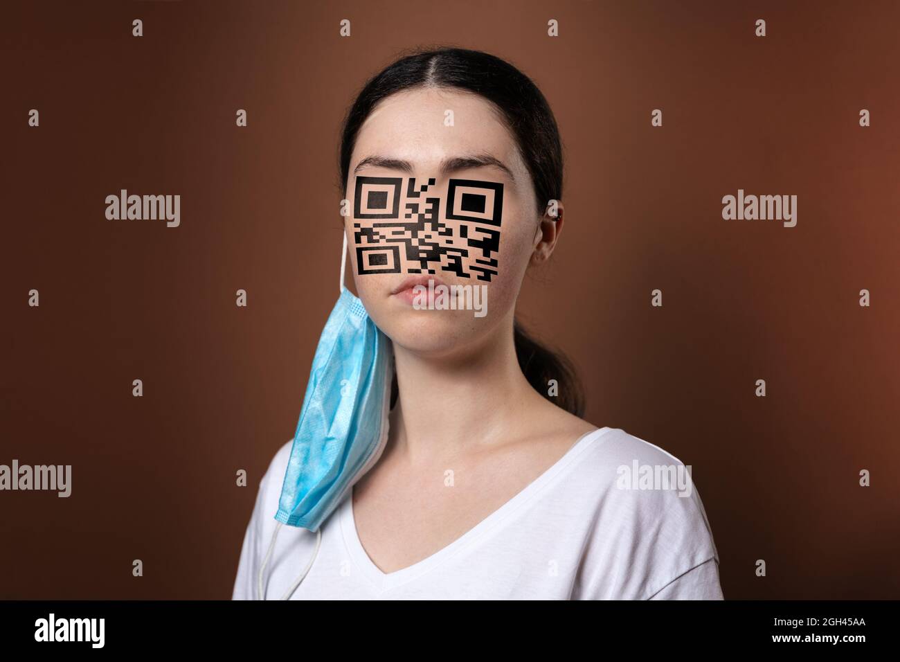 Portrait of a woman wearing protective mask with a QR code instead of a ...