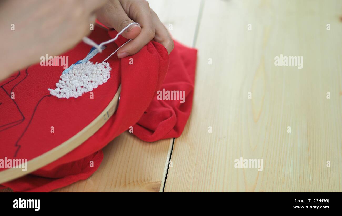 Embroider sewing by woman hand. Craft work and female hands. Handicraft ...