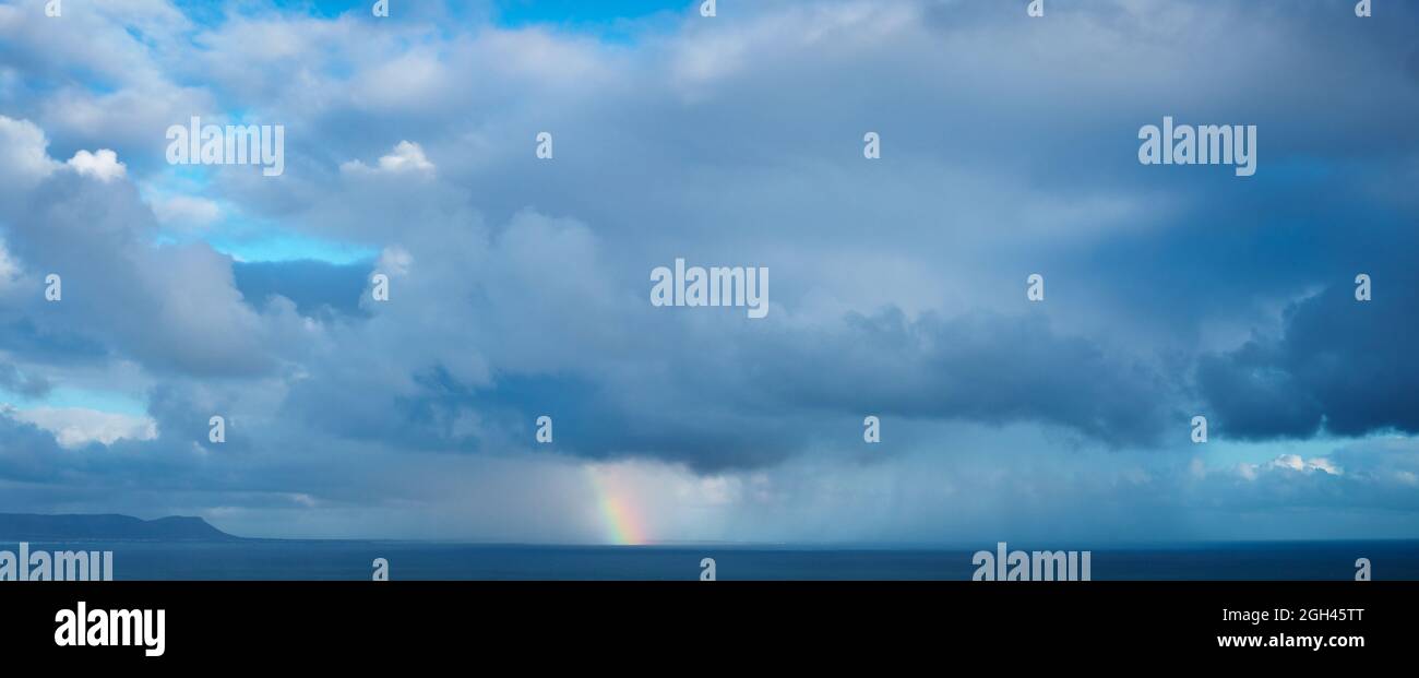 Rain squall, rainbow and storm at sea. Hermanus, Whale Coast, Overberg ...