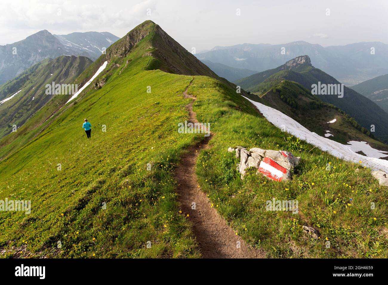 A hiker standing near a hiking trail on top of the talijanka peak (Maja ...