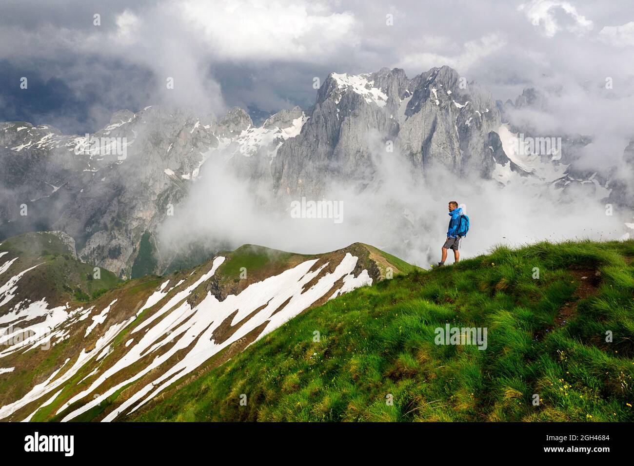 A hiker on top of the spectactular talijanka peak (Maja e Vajushës peak ...