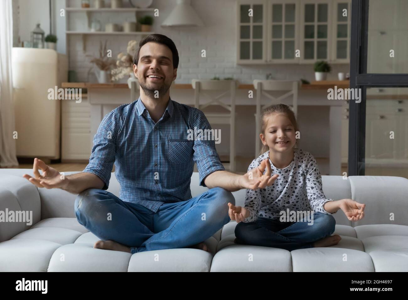 Happy calm dad and daughter meditating at home Stock Photo - Alamy
