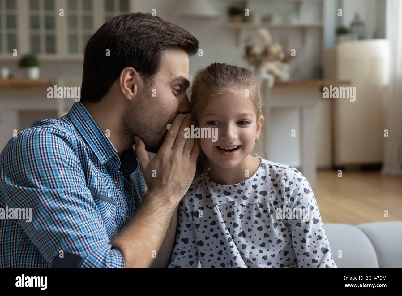 Happy dad sharing secret with excited joyful daughter Stock Photo - Alamy