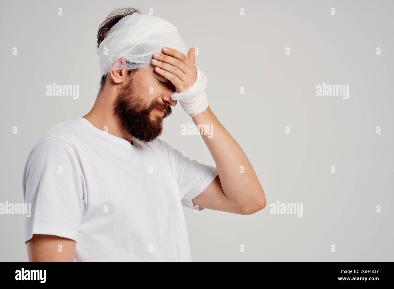 patient bandaged head and hand blood light background Stock Photo - Alamy