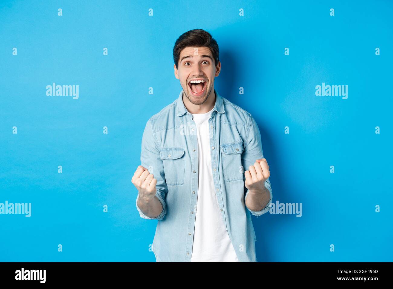 Excited handsome man winning, feeling lucky and rejoicing, celebrating ...
