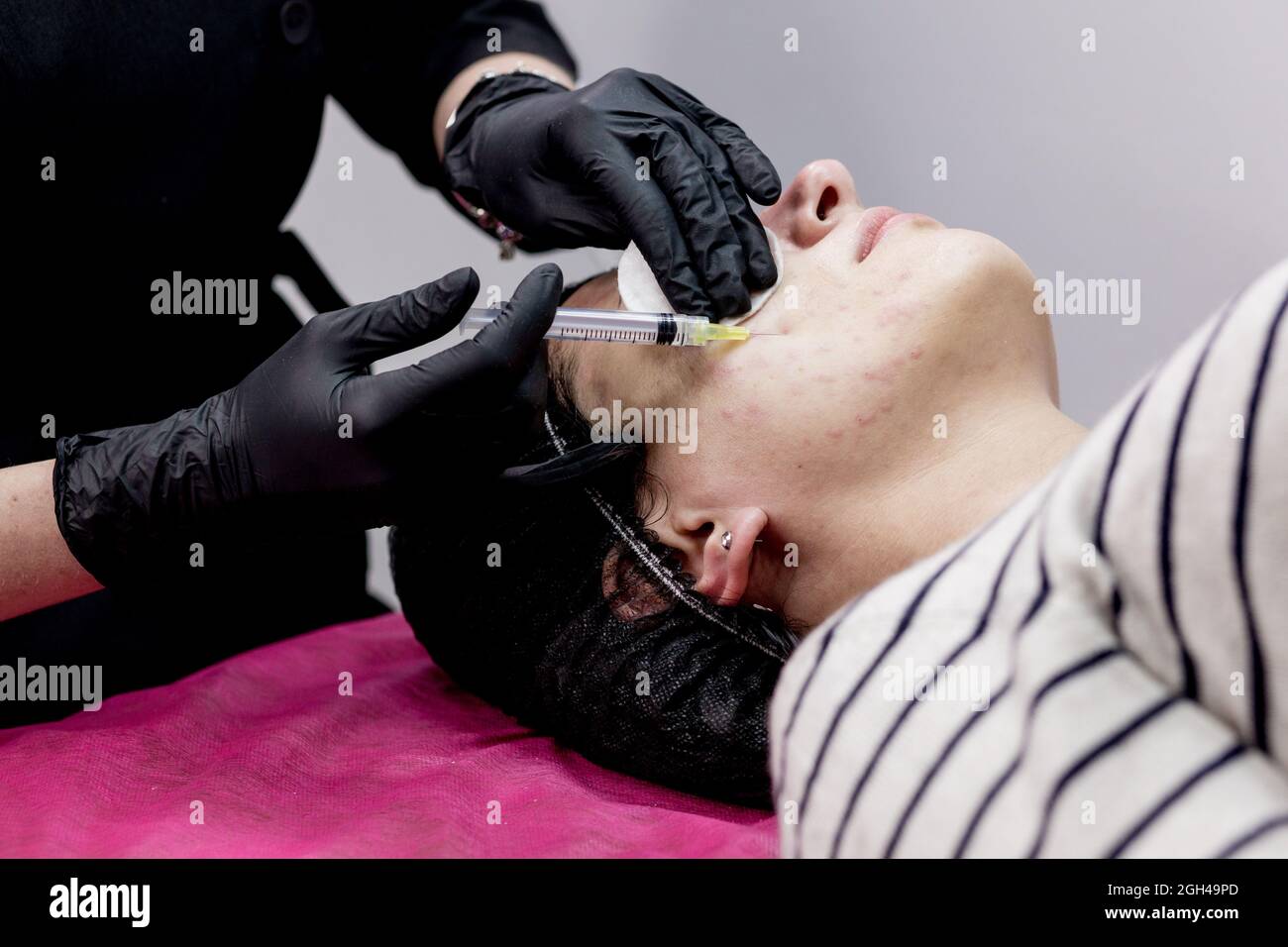 Face mesotherapy procedure in a beauty salon. Beautician doctor makes ...