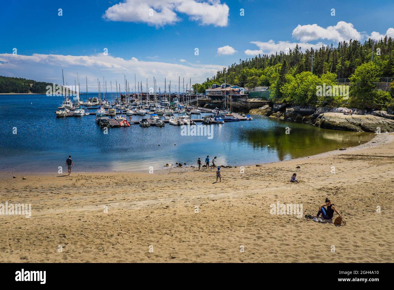 The sandy beach and marina of the Tadoussac Bay on a beautiful summer ...