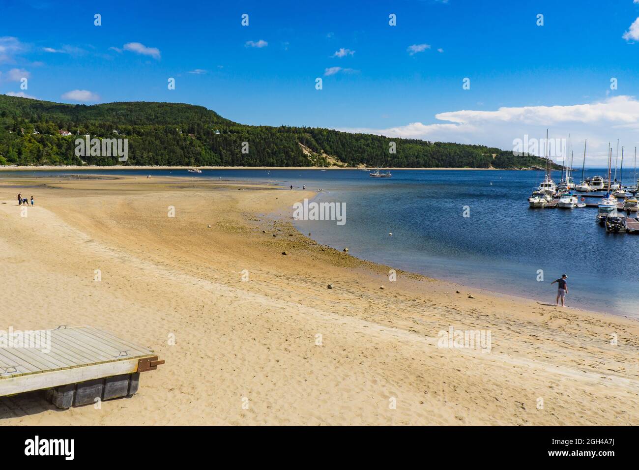 The sandy beach and marina of the Tadoussac Bay on a beautiful summer ...