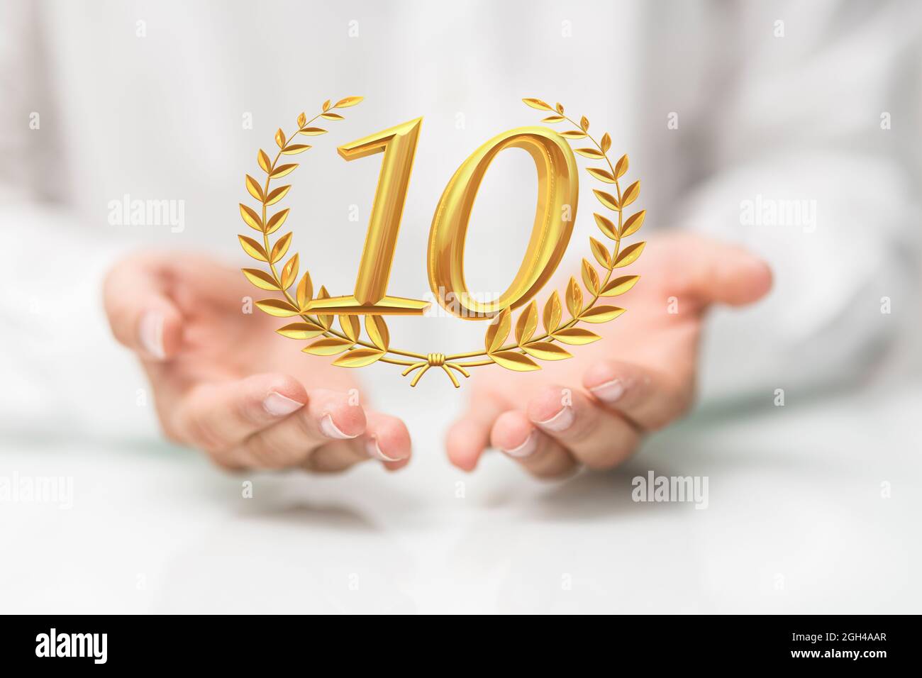 A digital 10 years anniversary award in a hand Stock Photo - Alamy