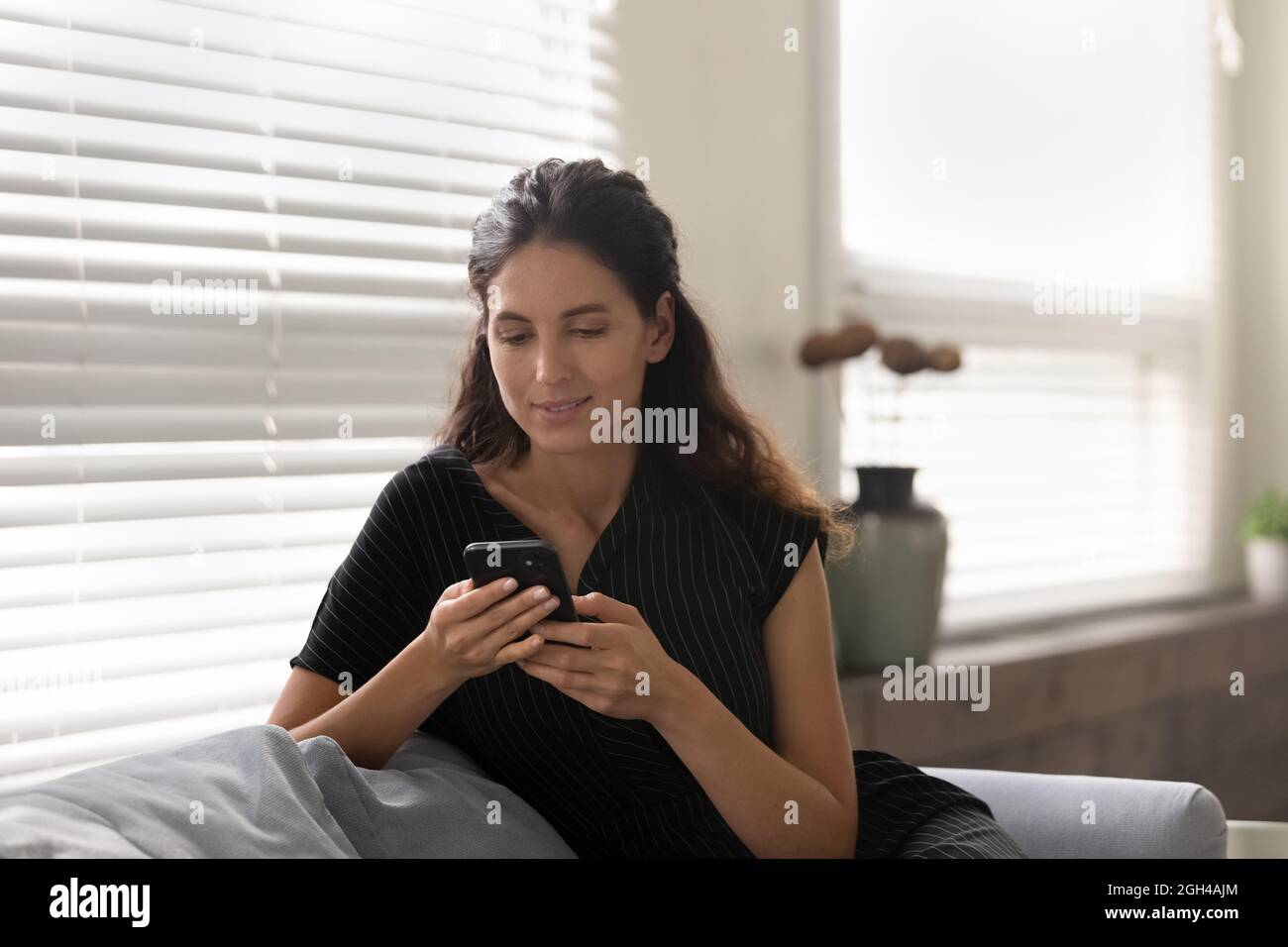 Serious thoughtful mobile phone user reading text message on screen ...