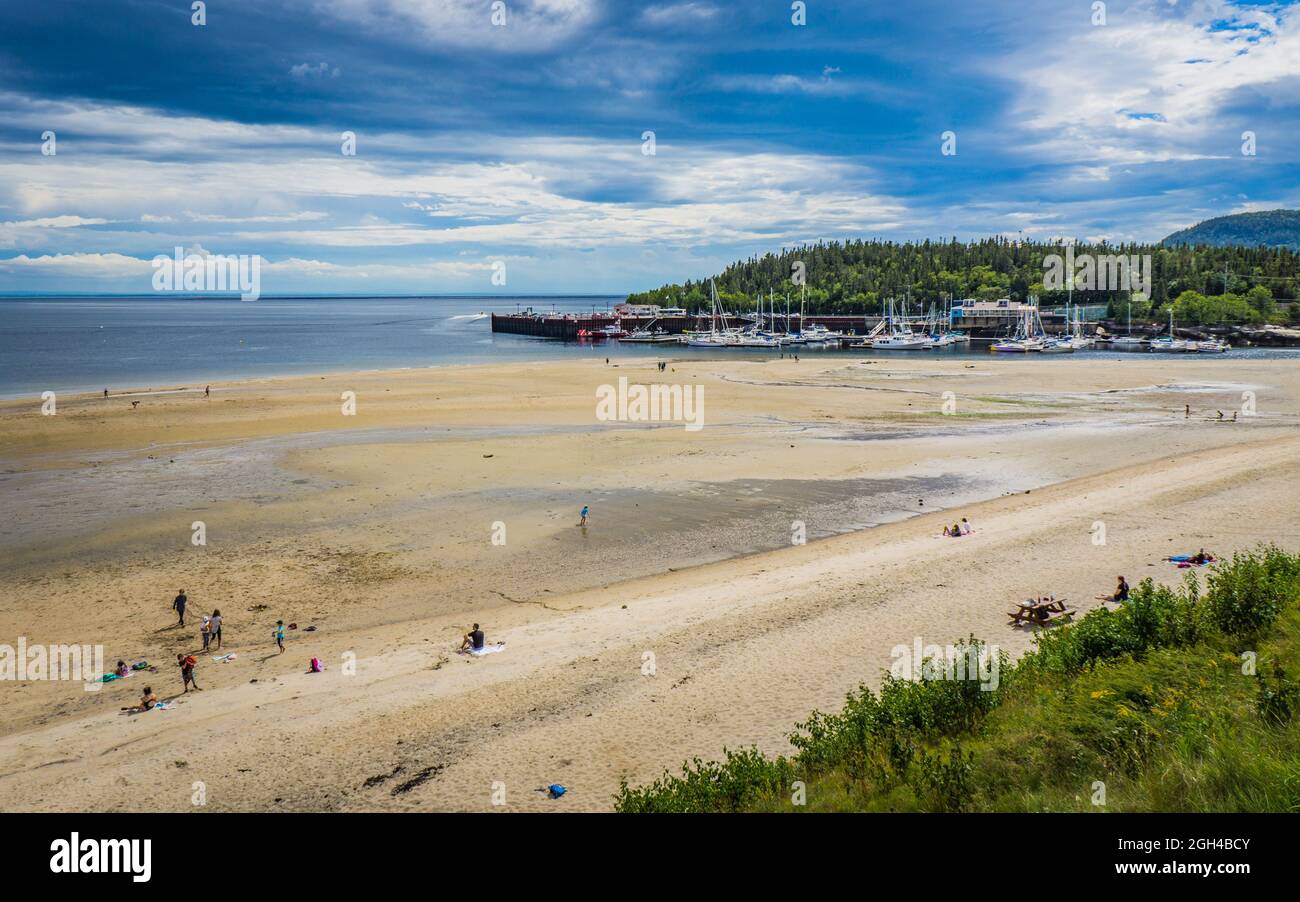The sandy beach and marina of the Tadoussac Bay on a beautiful summer ...
