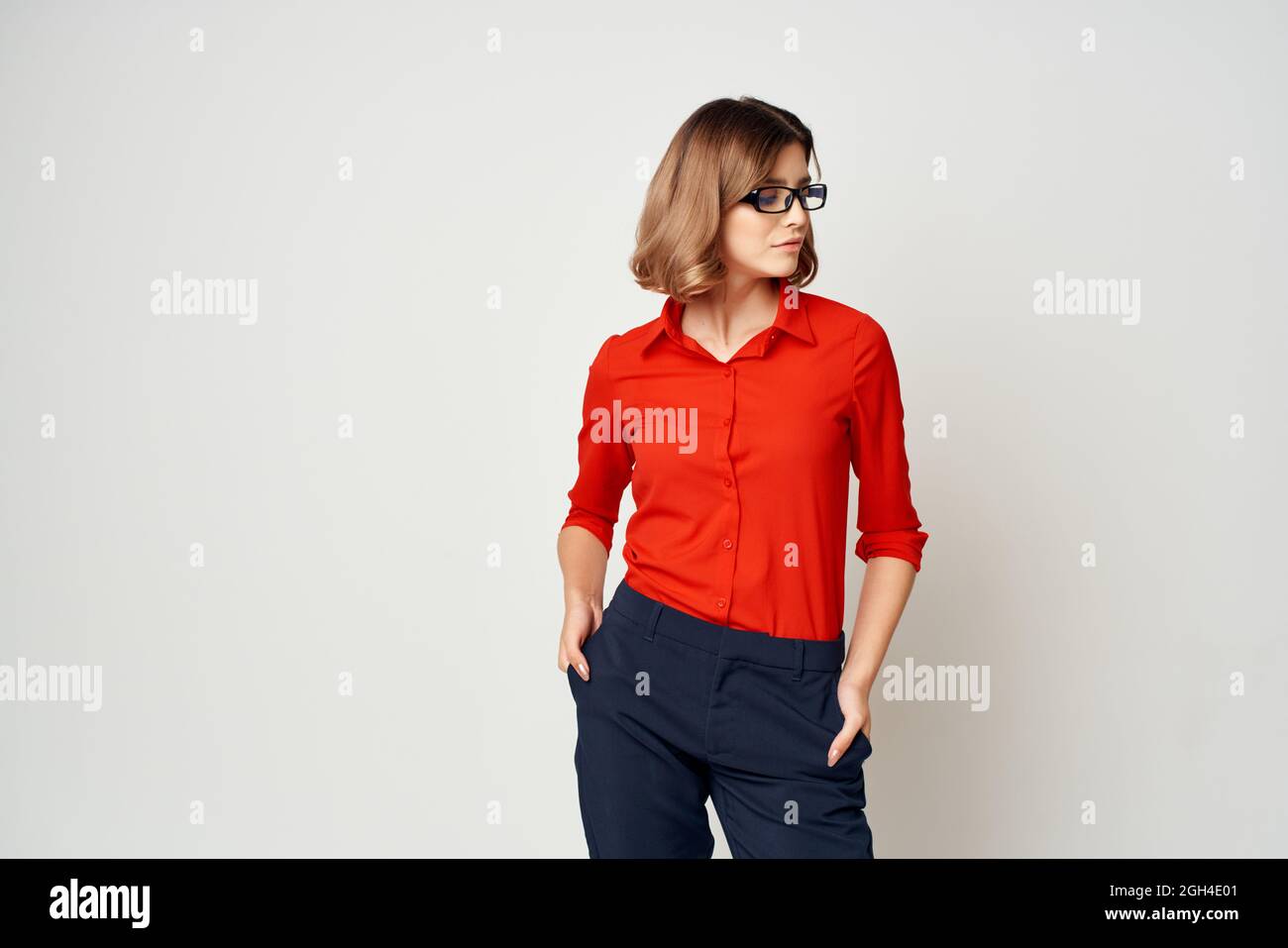 Businesswoman in a red shirt success light background Stock Photo - Alamy