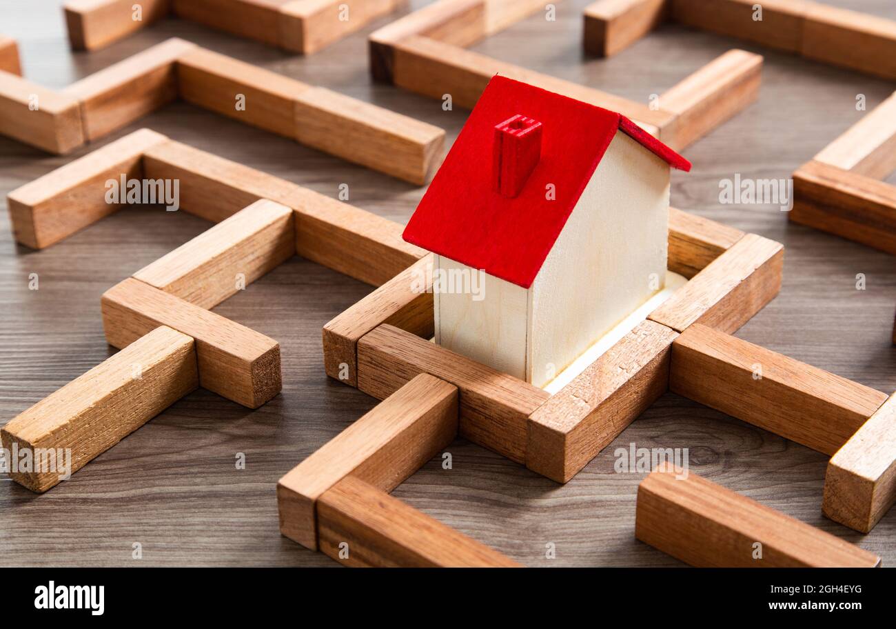 real estate concept, wooden house with maze Stock Photo - Alamy