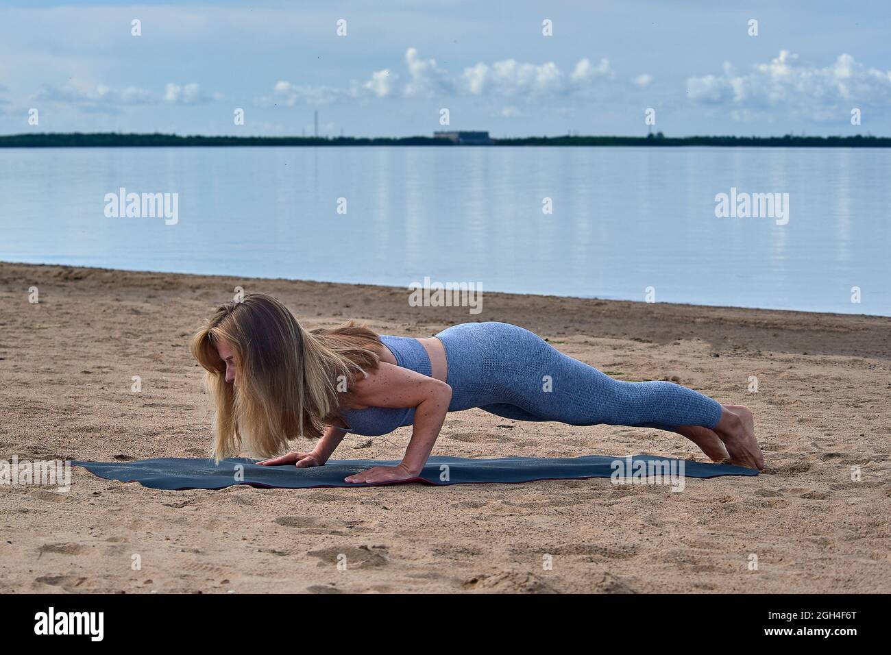 Woman doing yoga sandy hi-res stock photography and images - Alamy
