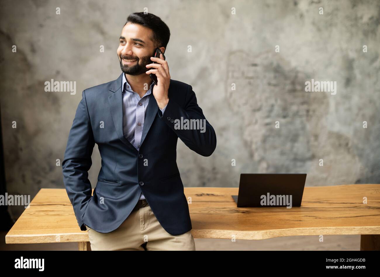Smiling Indian high skilled leader talking on the smartphone, ceo has ...