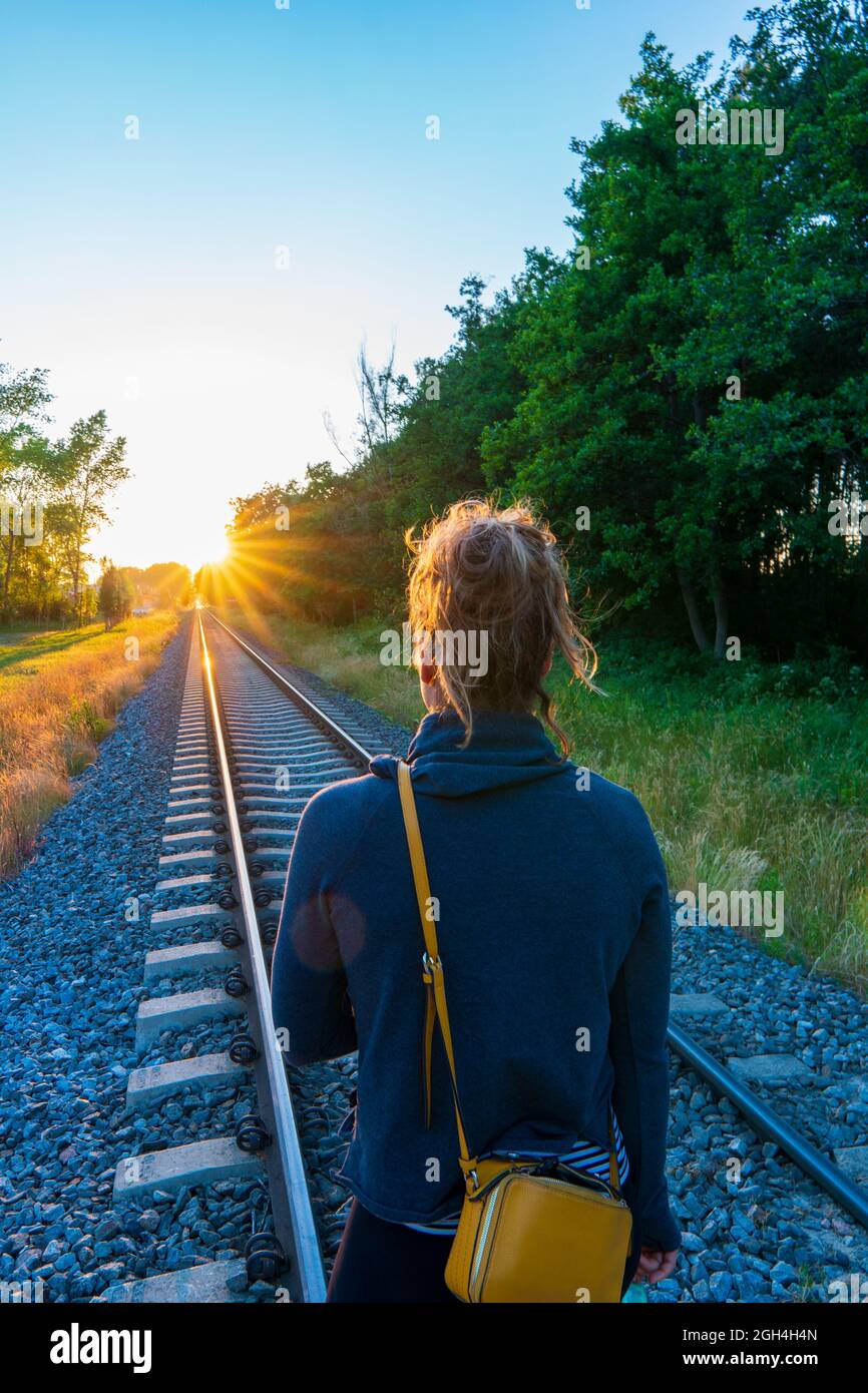 daily life of a woman walking along the rail track Stock Photo - Alamy