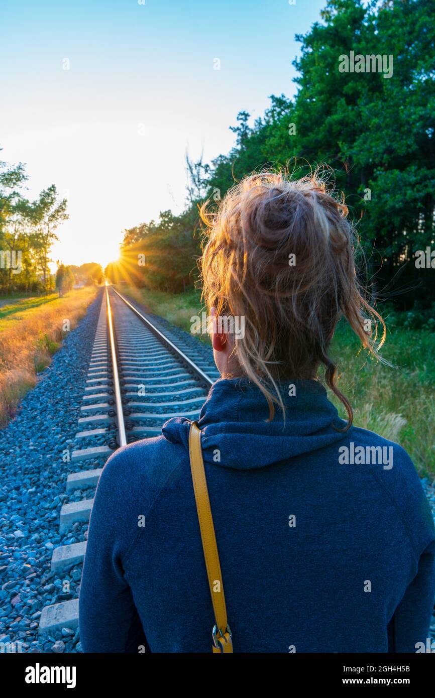 daily life of a woman walking along the rail track Stock Photo - Alamy