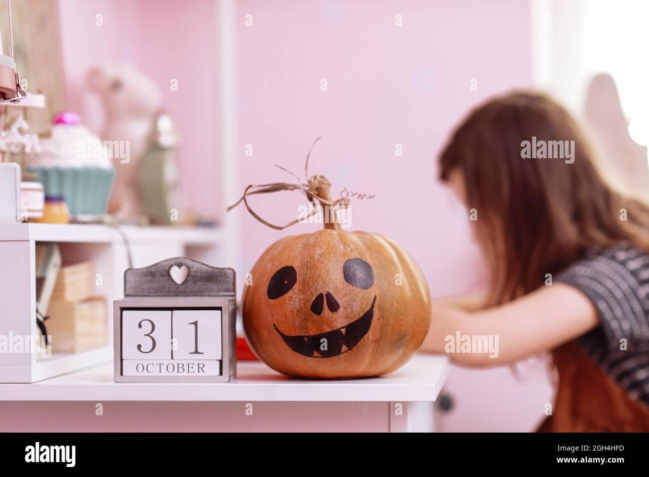 Halloween pumpkin and calendar with 31 october on wooden table in ...