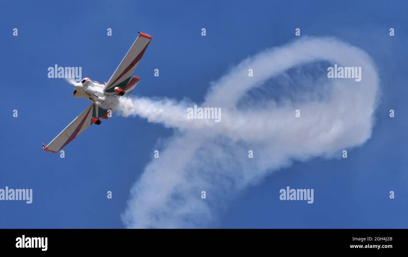 Ferrara Italy JUNE, 27, 2021 Small propeller aerobatic plane draws a ...