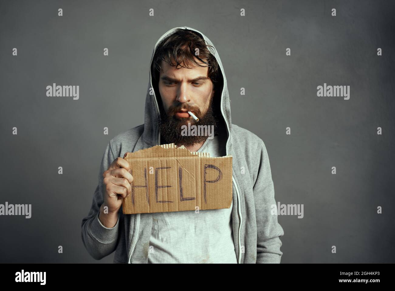 poor man with a beard sign help the tramp lifestyle Stock Photo - Alamy