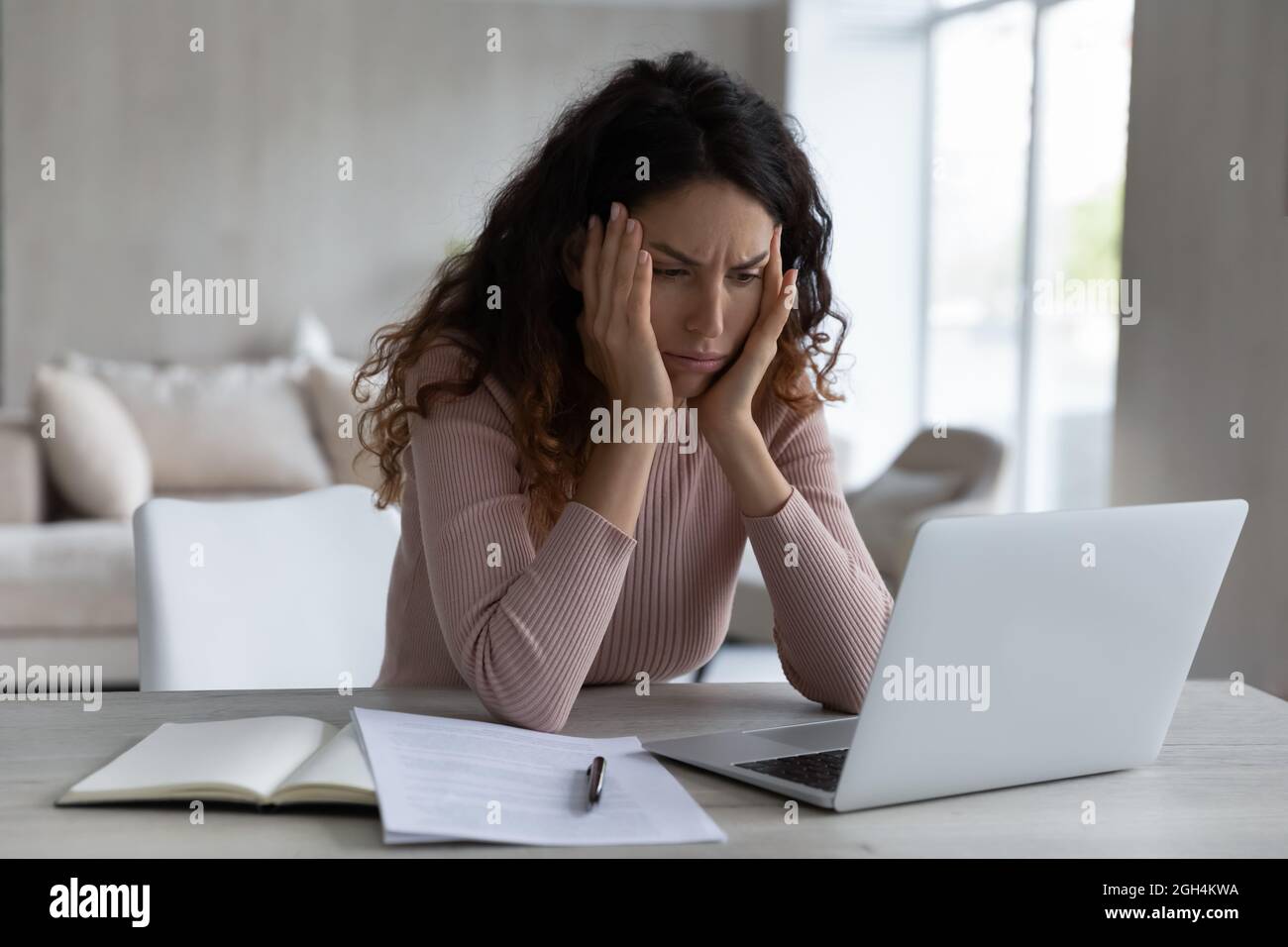 Stressed young hispanic woman looking at computer screen Stock Photo ...