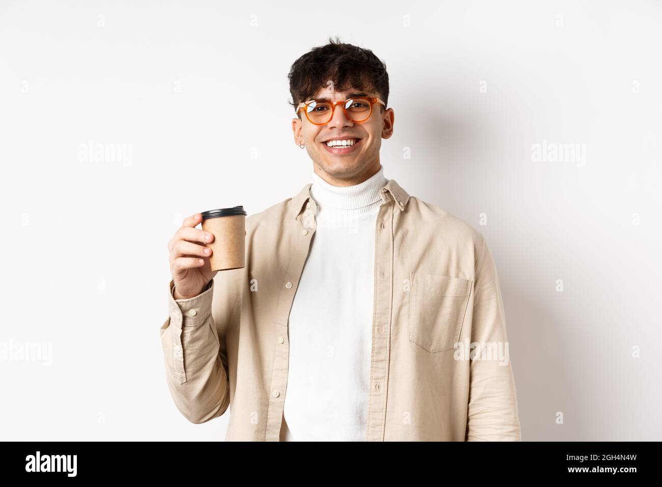 Real people. Happy young man drinking coffee from paper cup, order ...