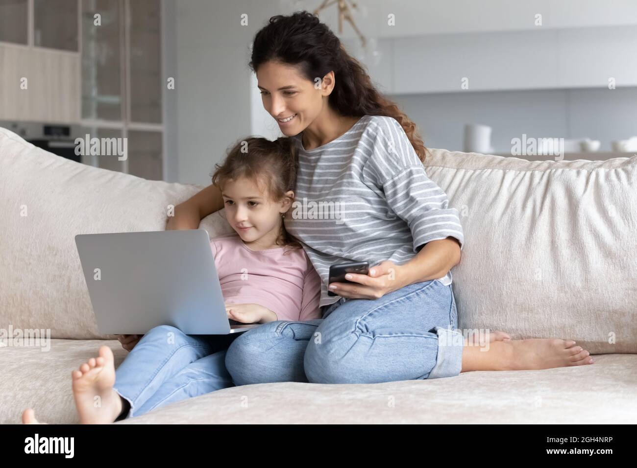 Family using different technology hi-res stock photography and images ...