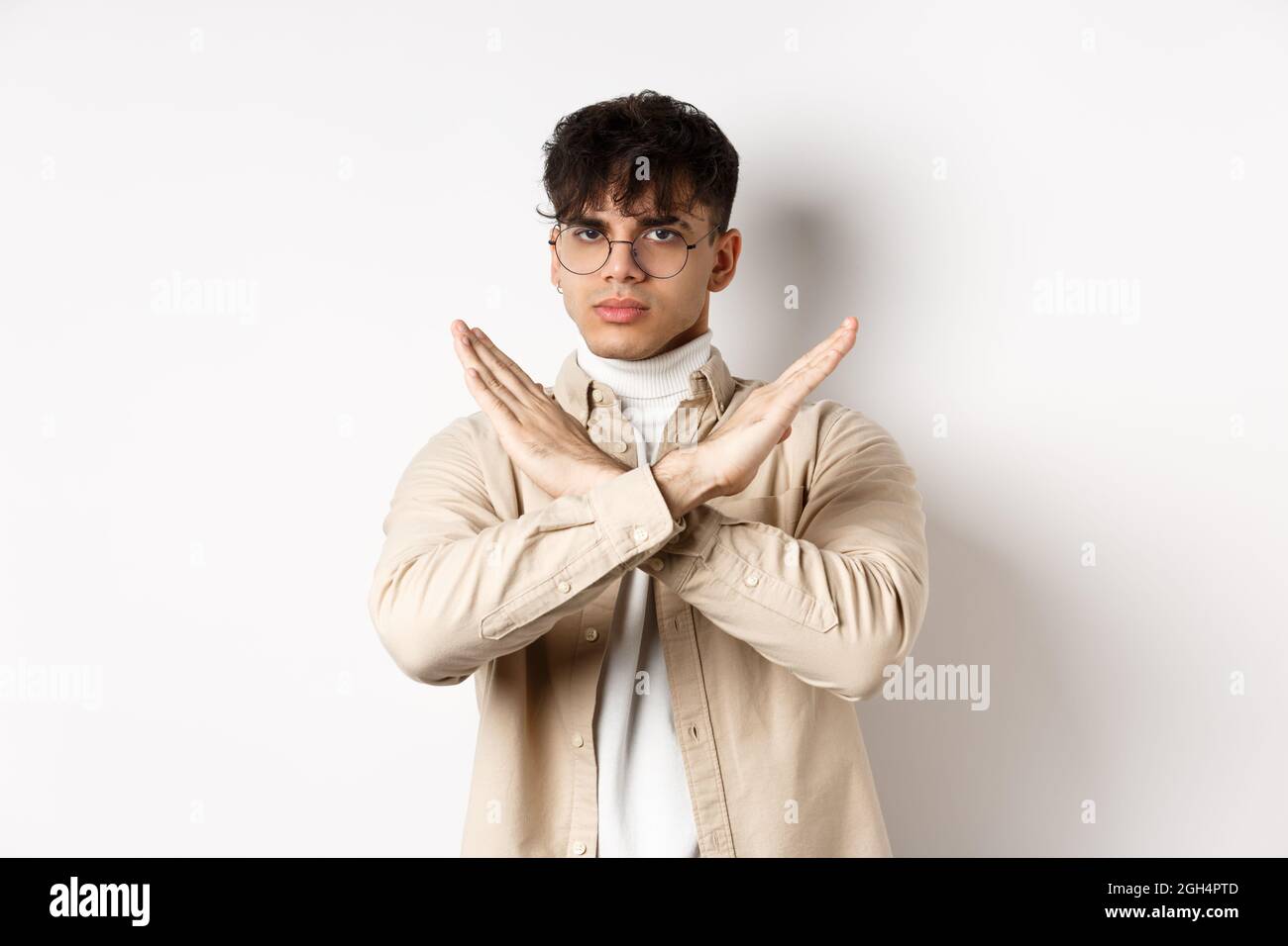 Image of serious young guy in glasses say no, showing cross gesture ...