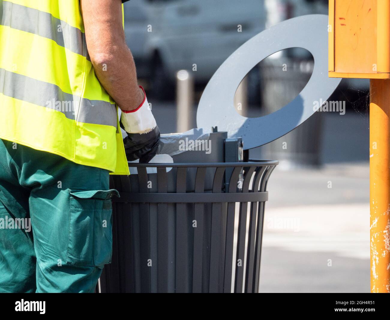 operator with reflective life jacket and rubber gloves replaces the bag ...