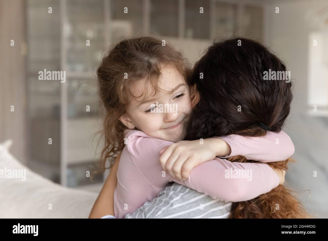 Adorable little kid girl embracing affectionate young mother Stock ...