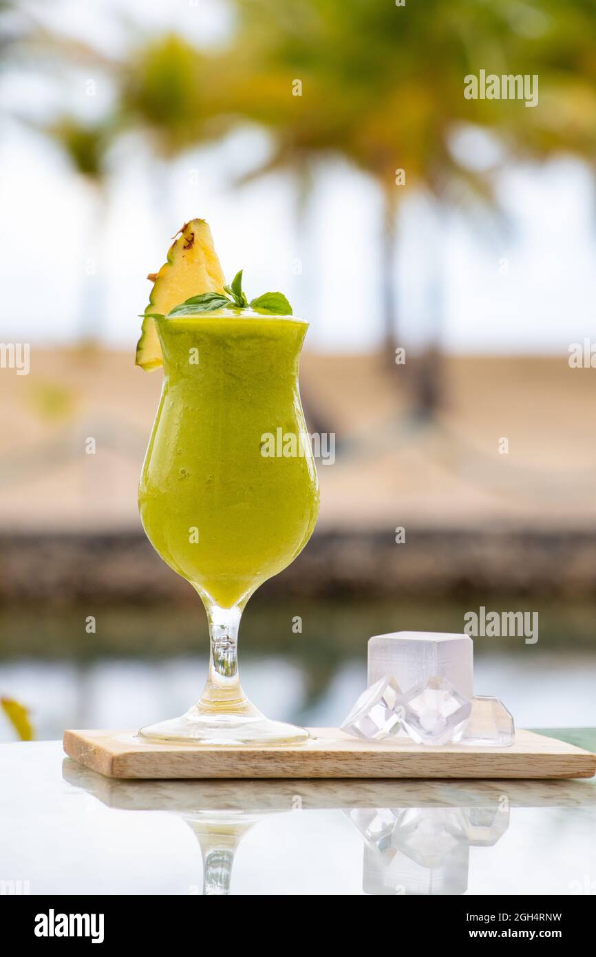 fruit smoothie with beach background Stock Photo - Alamy