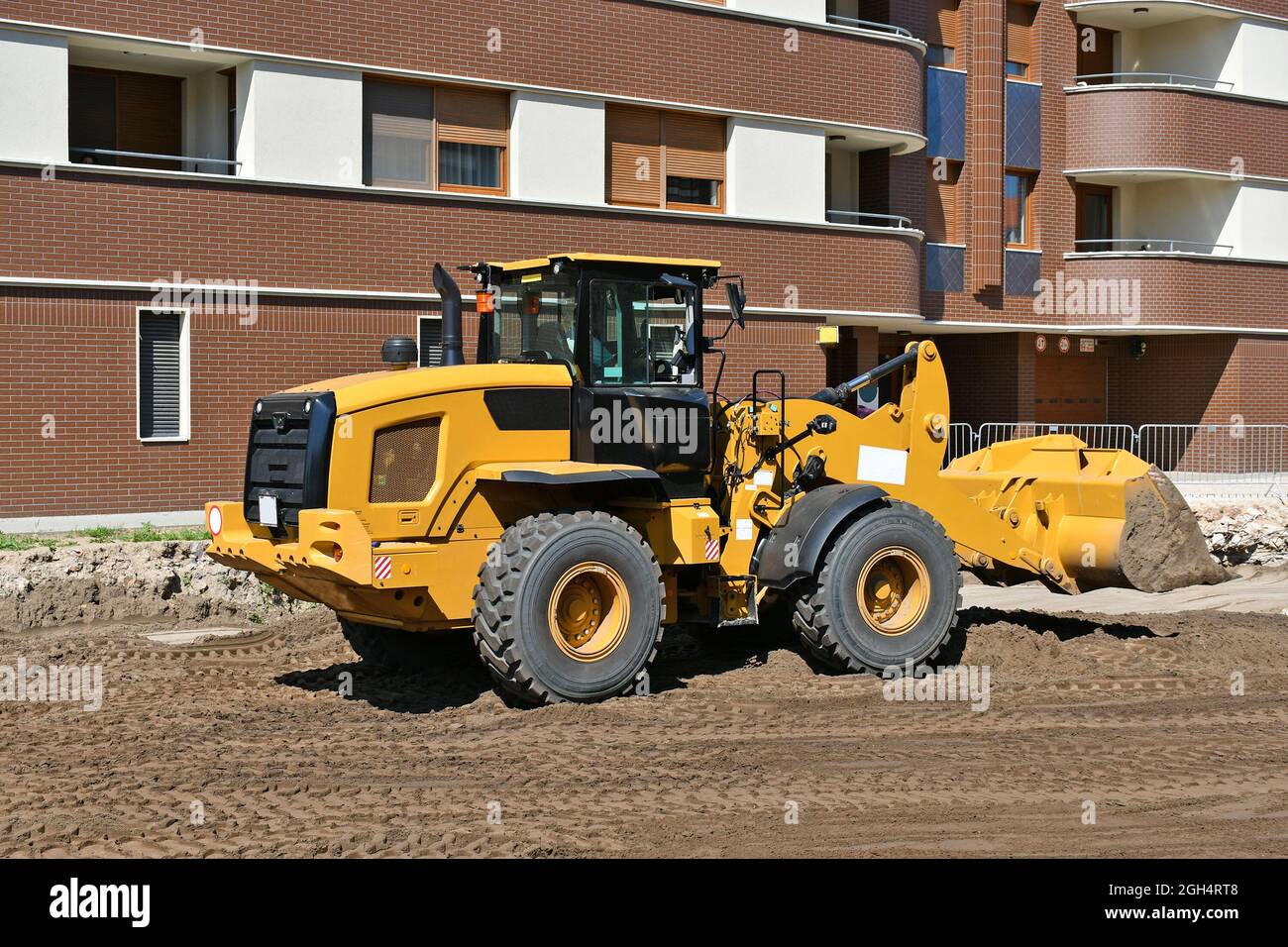Excavator at the road construction in the city Stock Photo - Alamy