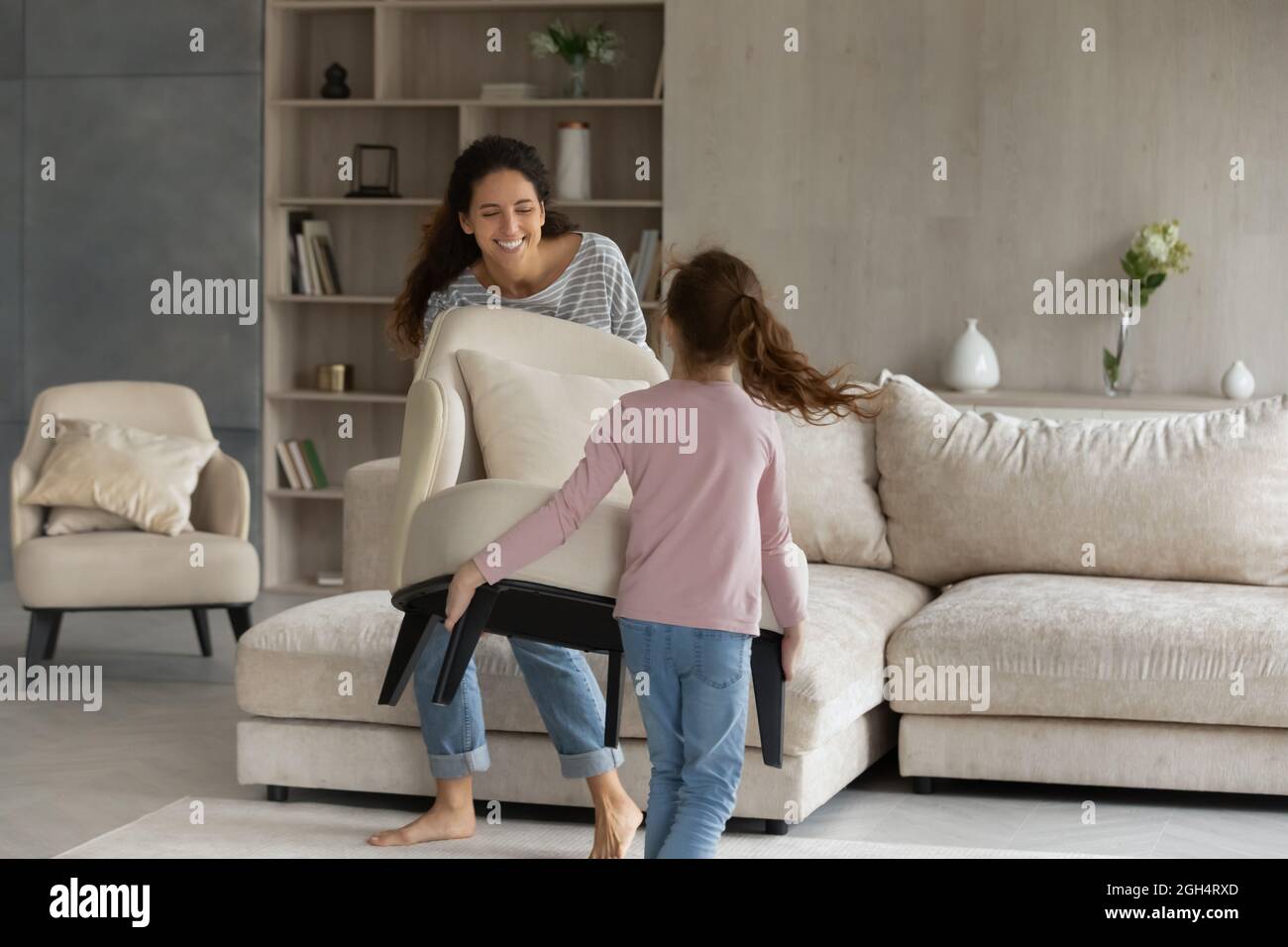 Happy two gen female family homeowners decorating house together Stock ...