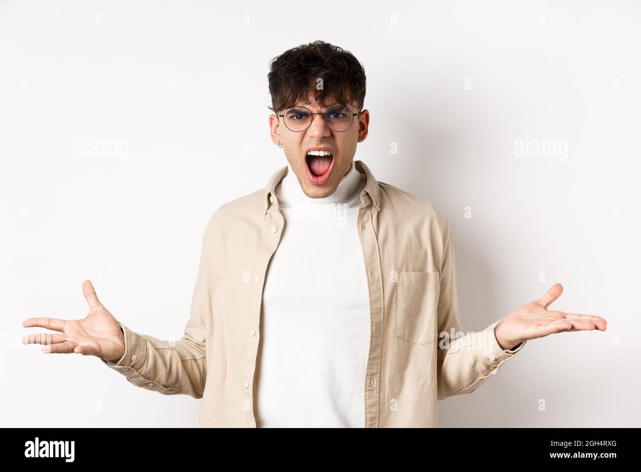Portrait of angry frustrated man shouting and having argument, spread ...