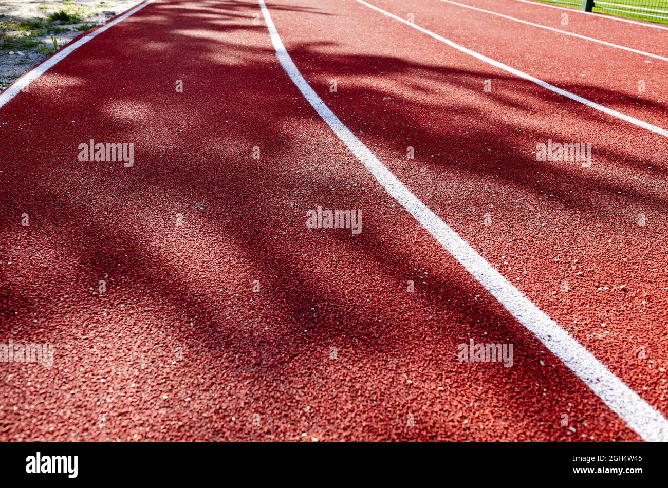 Red treadmill on sport field. Running track on the stadium Stock Photo ...