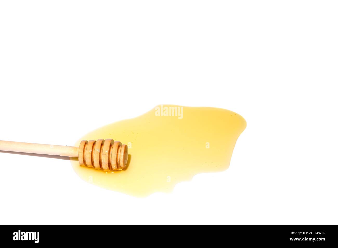 Honey drip from wooden dipper isolated on white background Stock Photo ...