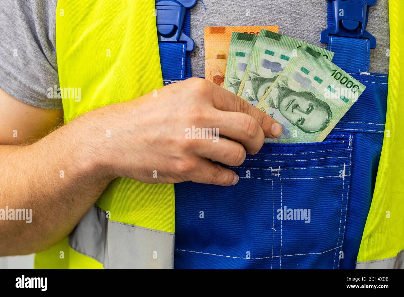 Worker counting his earnings, Costa Rica money, Concept of wages and ...