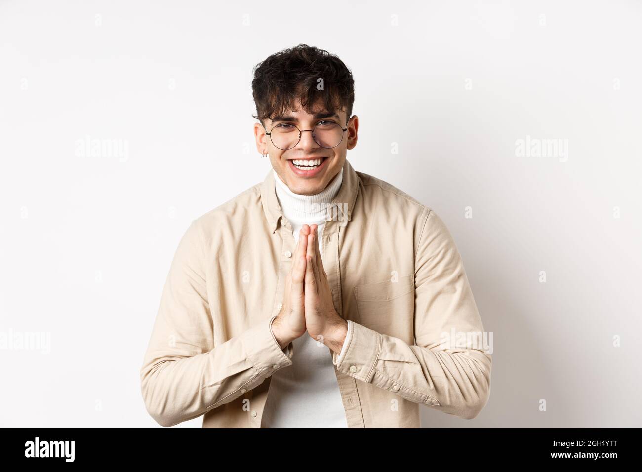Handsome caucasian man say thank you, bowing with namaste gesture ...