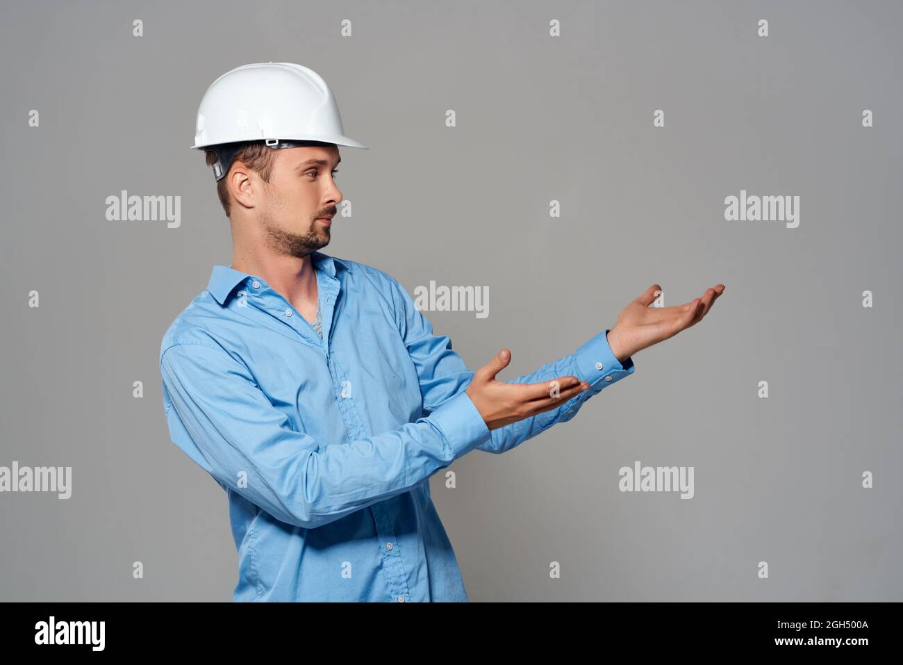 engineer with drawings in hand hand gesture light background Stock ...