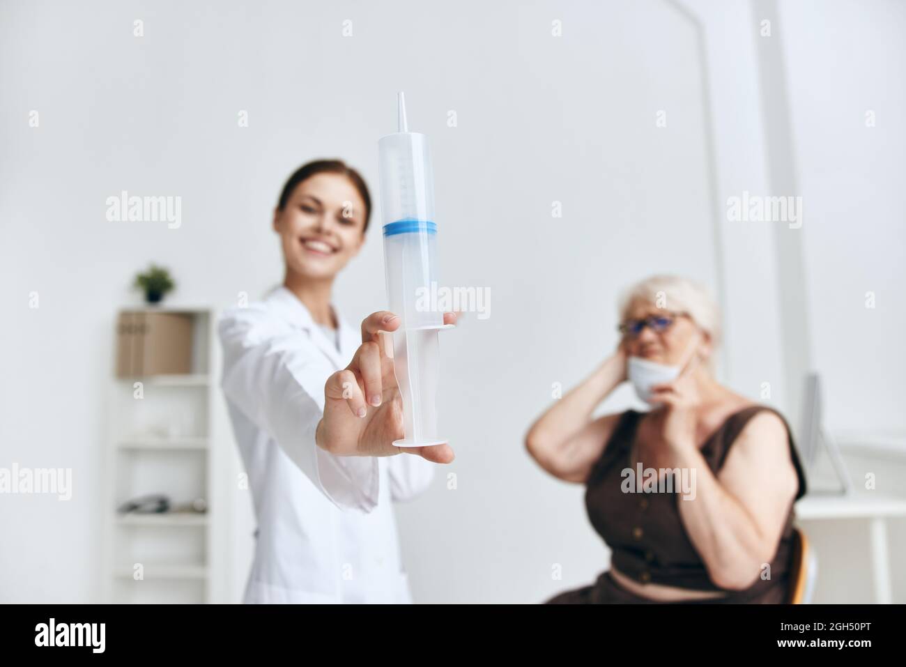 emotional elderly woman hand injection fun Stock Photo - Alamy