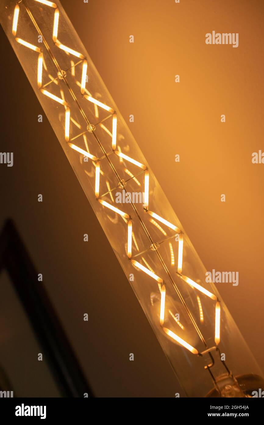 Vintage Edison Long Tube Spiral Filament Bulb on the wall Stock Photo ...