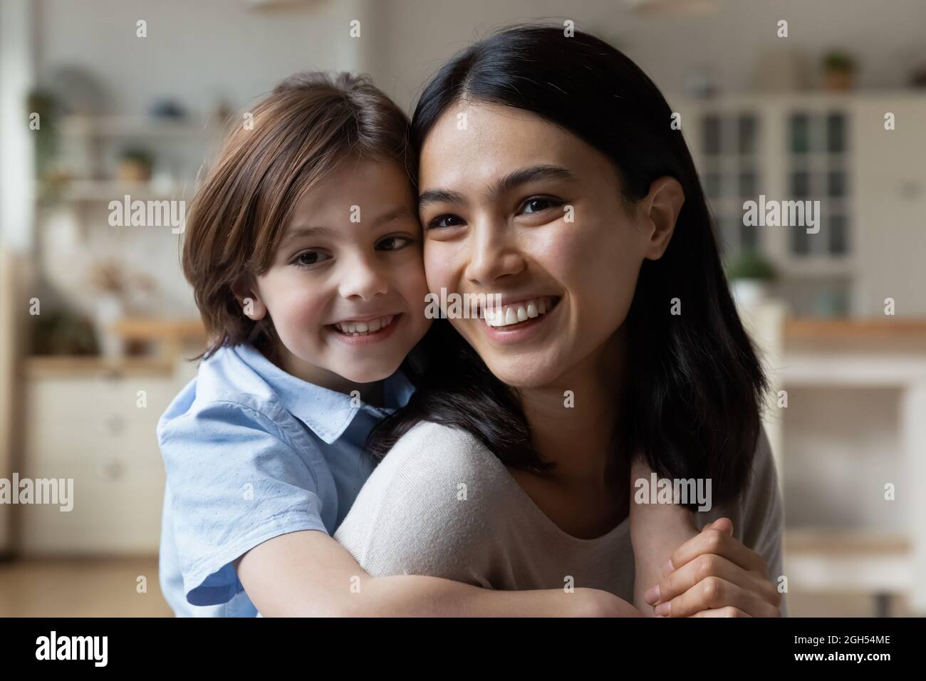 Happy cute small boy cuddling beautiful asian korean mother Stock Photo ...