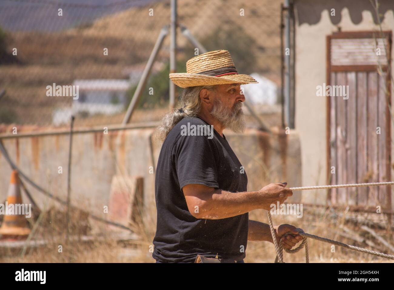 Spanish man farmer with hat, holding rope, Andalusia, Spain Stock Photo ...