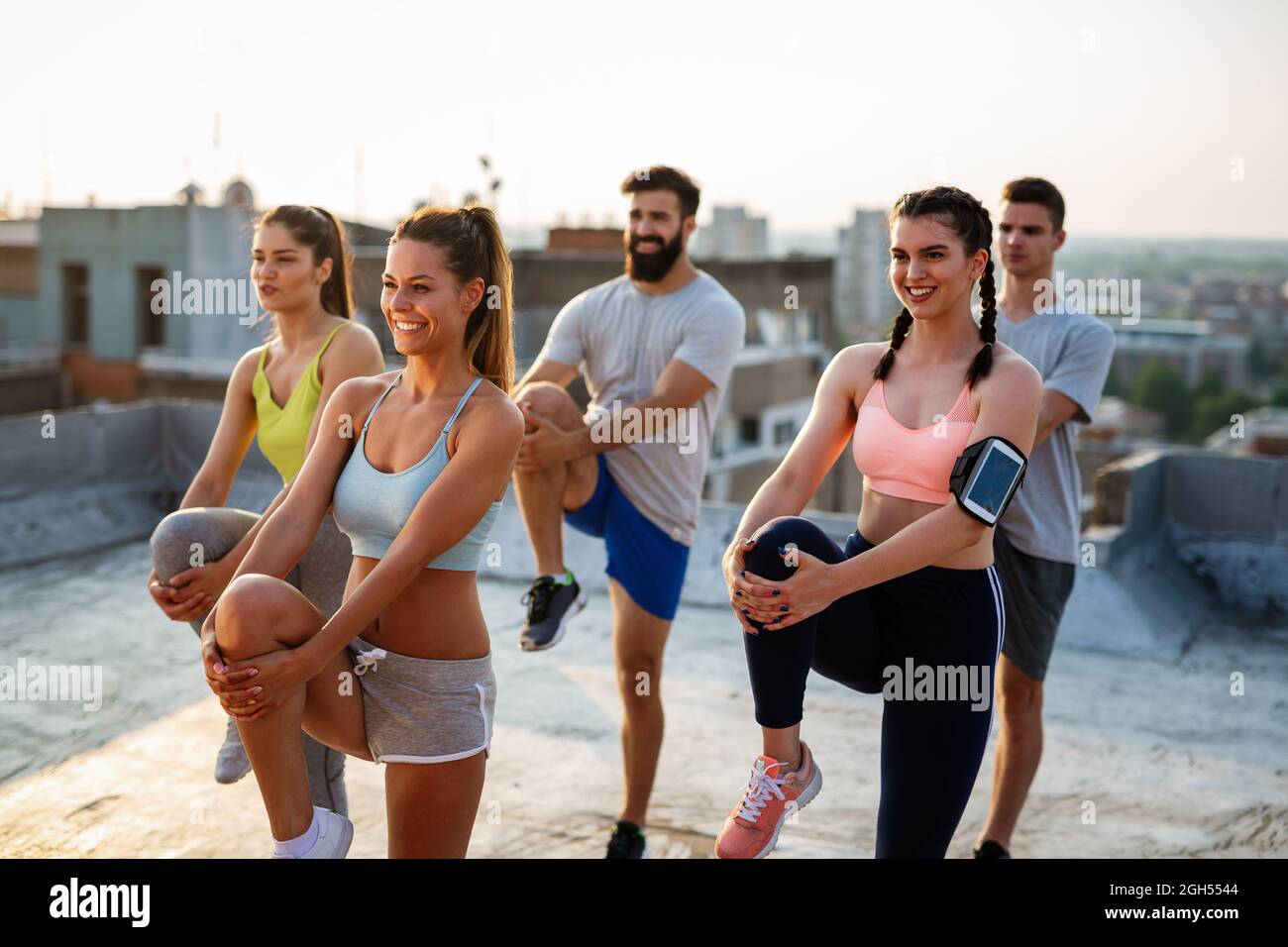 Group of fit healthy friend, people exercising together outdoor Stock ...