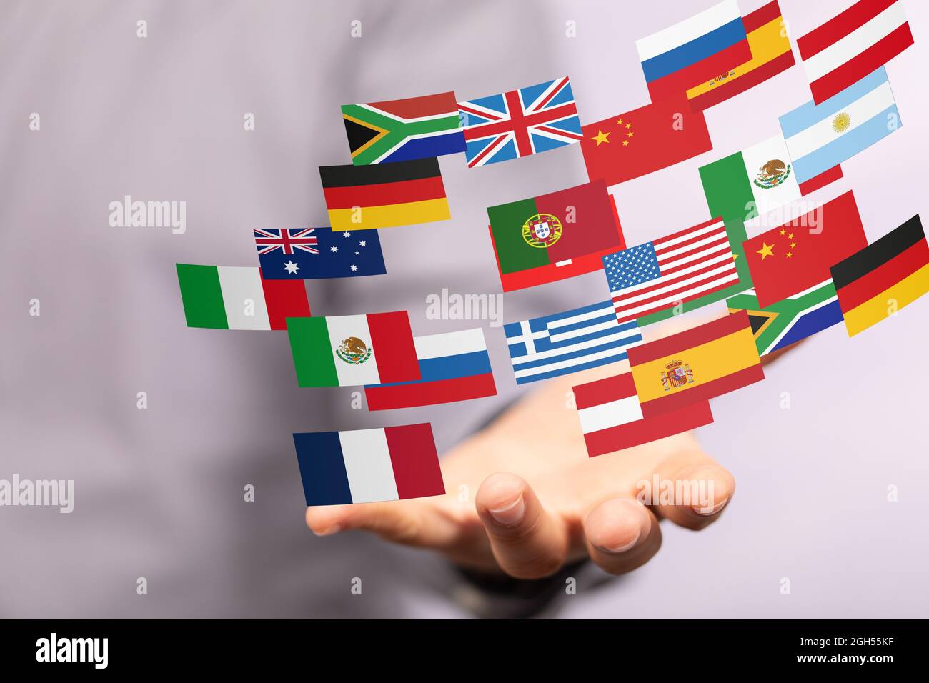 An illustration of national flags of different countries in a hand ...