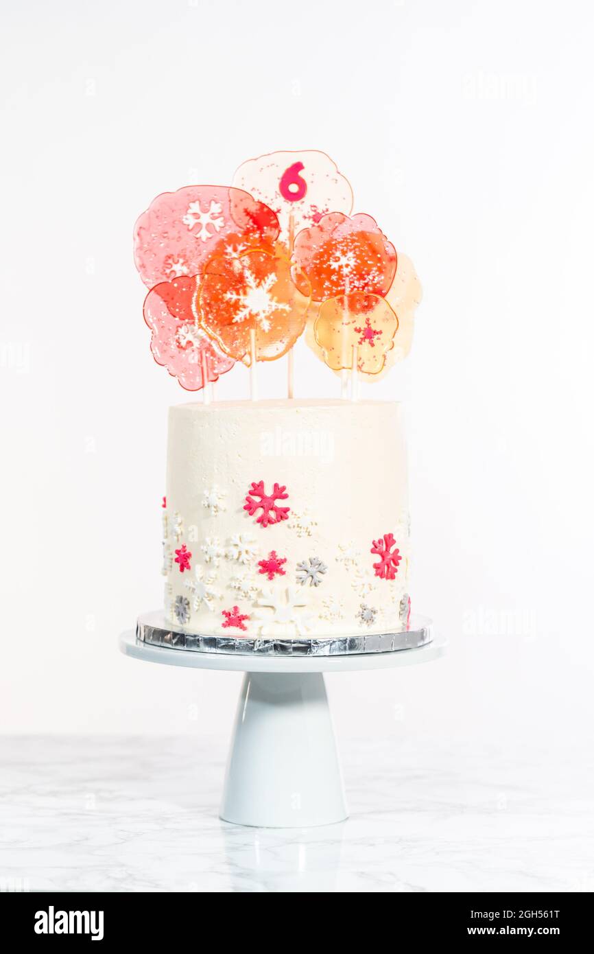 Tall round cake with Italian buttercream frosting decorated with ...