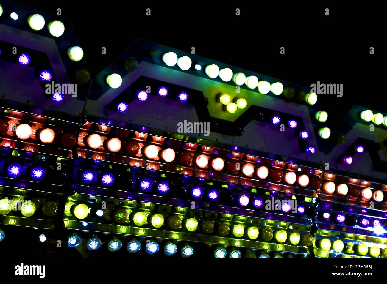 Illuminated amusement park lights Stock Photo - Alamy