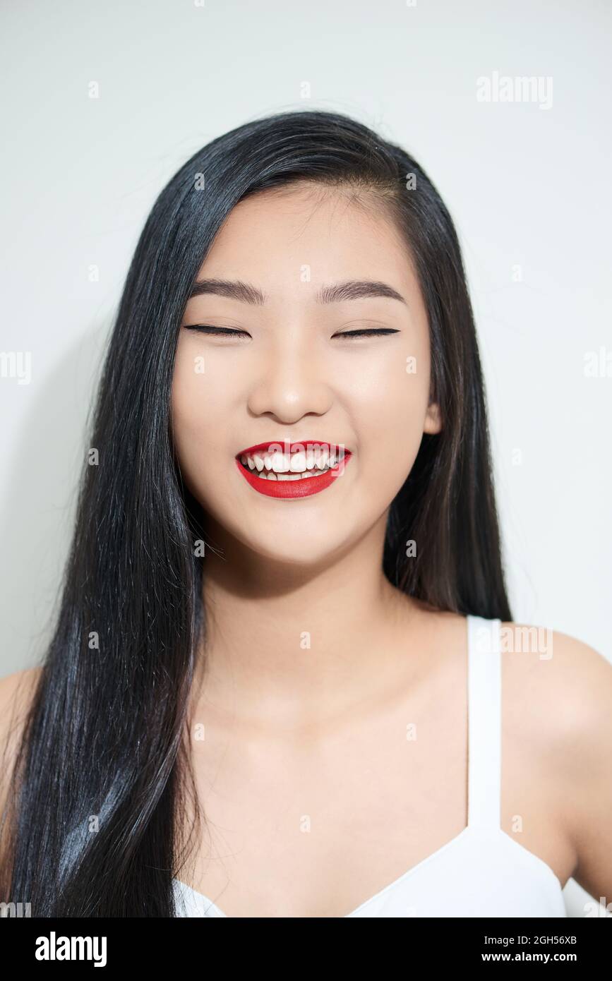 Young beautiful Asian woman with smiley face and red lips Stock Photo ...