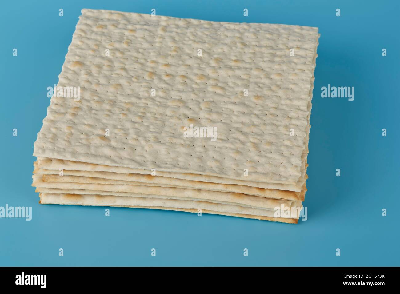 Traditional Jewish matzah for the holiday of Passover lies on a blue ...